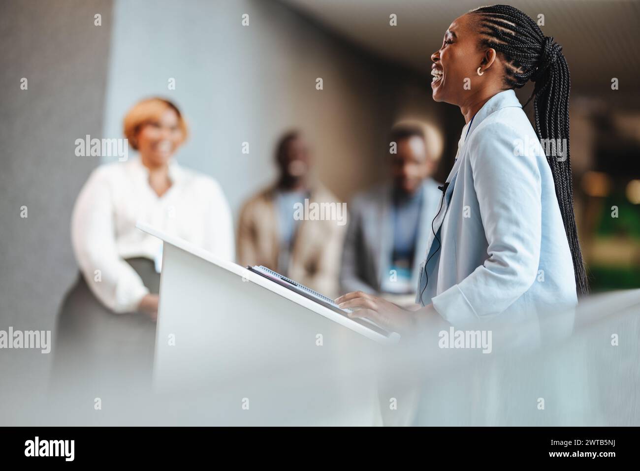 Successful African business woman engages with her audience while ...