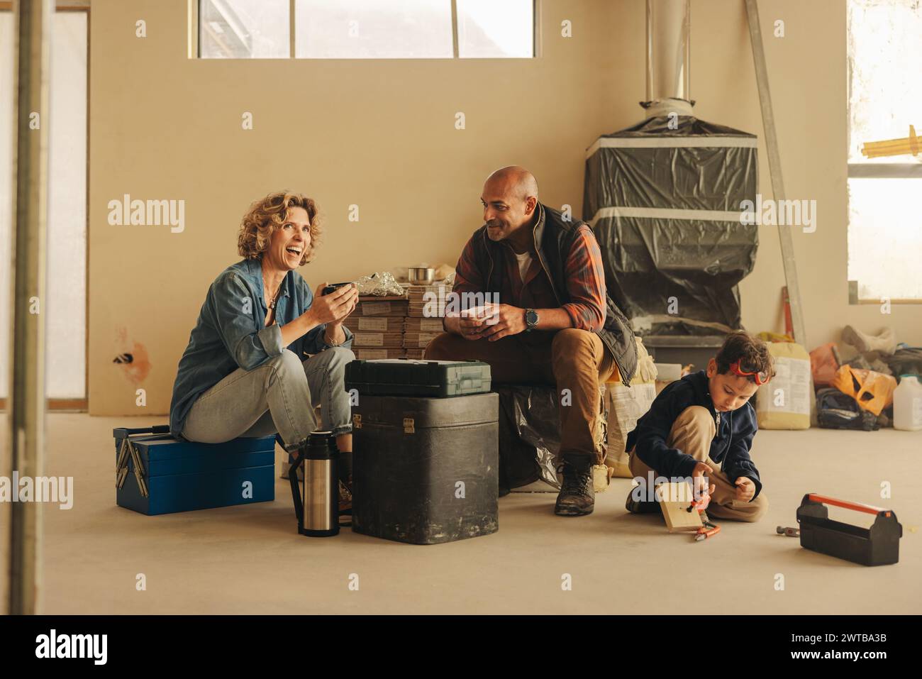During a home renovation project, a family takes a break. Mom and dad ...
