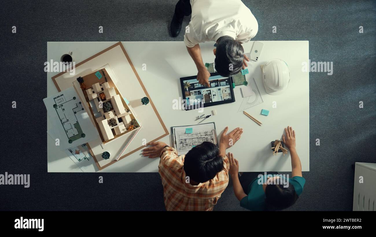 Top down view of civil architect looking at project plan while present ...