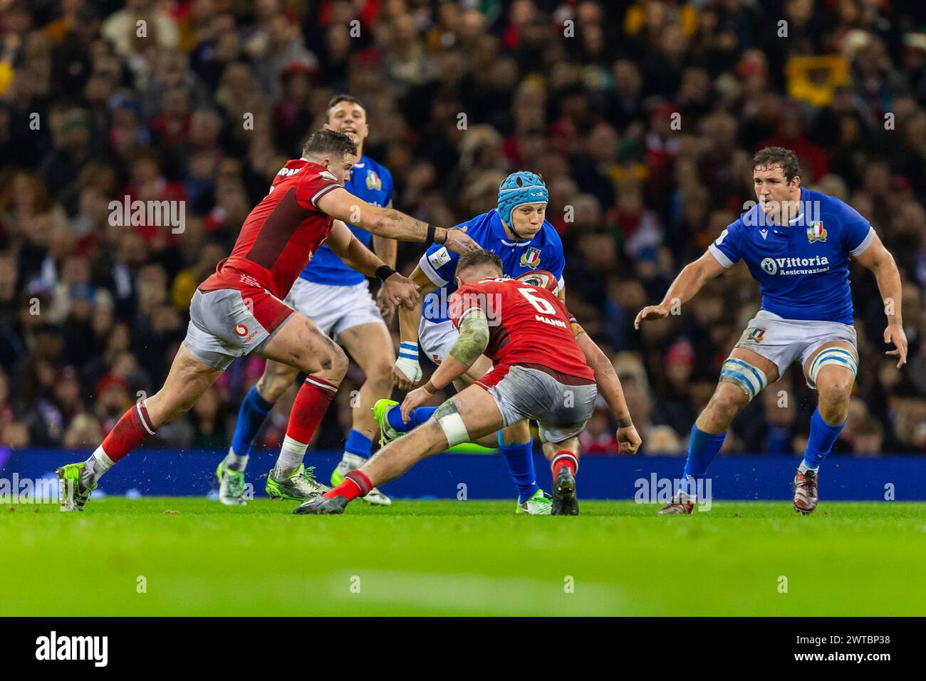 Cardiff, UK. 16th Mar, 2024. Ross Vintcent of Italy is tackled by Alex ...