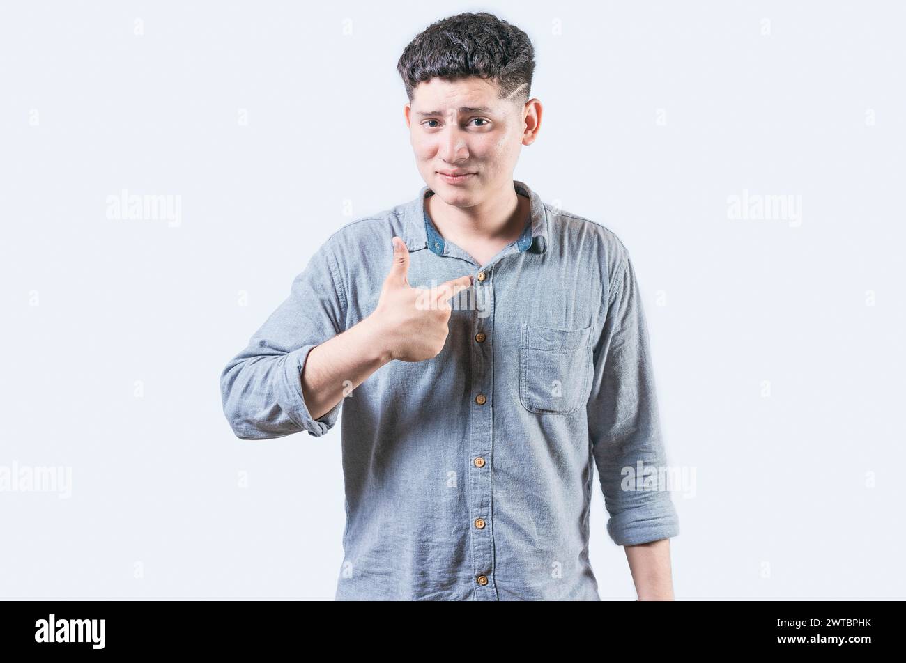 Embarrassed young man pointing at himself isolated. Confused man ...