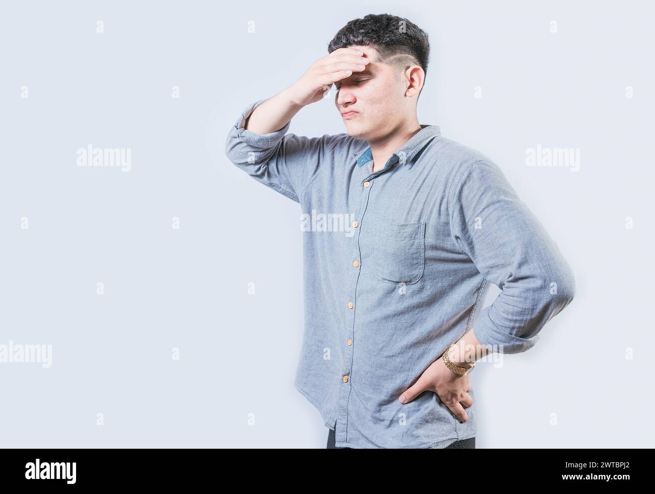 Tired man holding his head isolated. Worried young man holding his ...