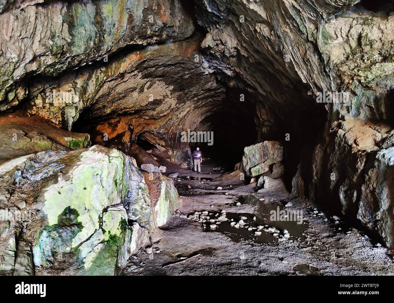 View into the Feldhof Cave with a person, Hoennetal, Balve, Maerkisches ...