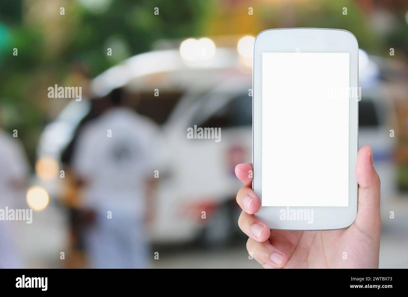 hand hold smartphone with Ambulance responding to emergency call ...