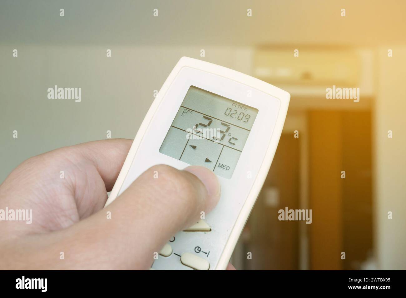 Hand hold remote control with conditioner background Stock Photo - Alamy