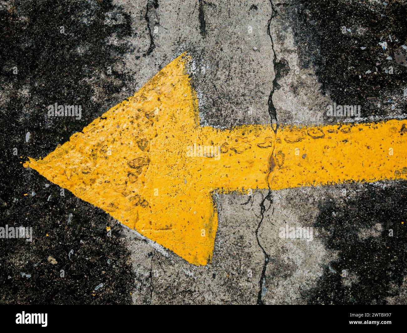 traffic direction arrow on the road, turn left sign Stock Photo - Alamy
