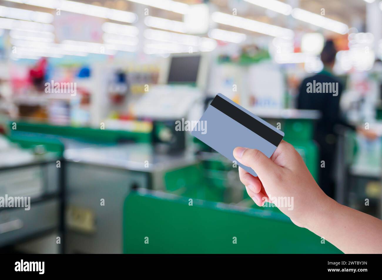 paying using credit card at supermarket checkout cashier counter in ...