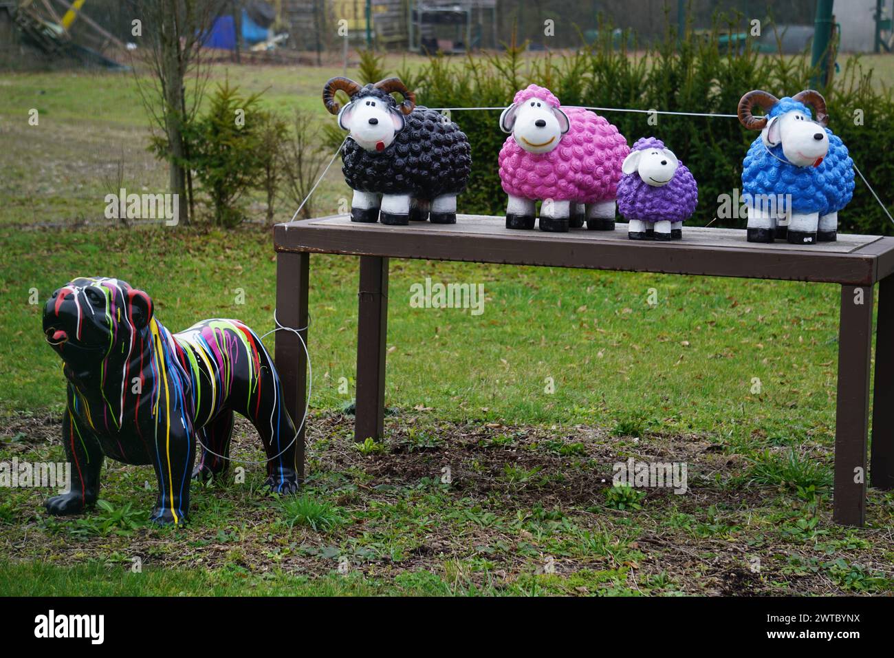 closeup on colorful sheep and dog sculptures on display in the park in ...