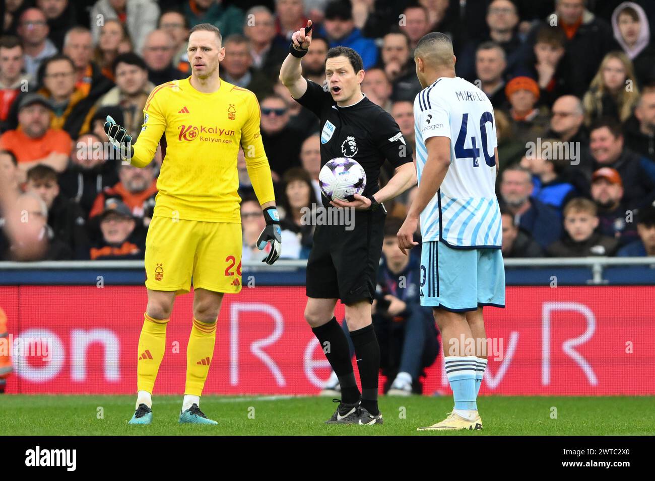 Referee, Darren England gestures to a Luton player before giving a drop ...