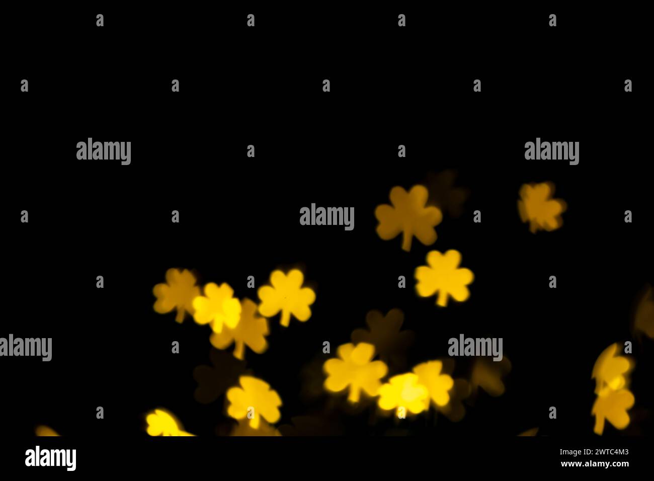 glare, bokeh, lights in the shape of clover leaves on a black ...