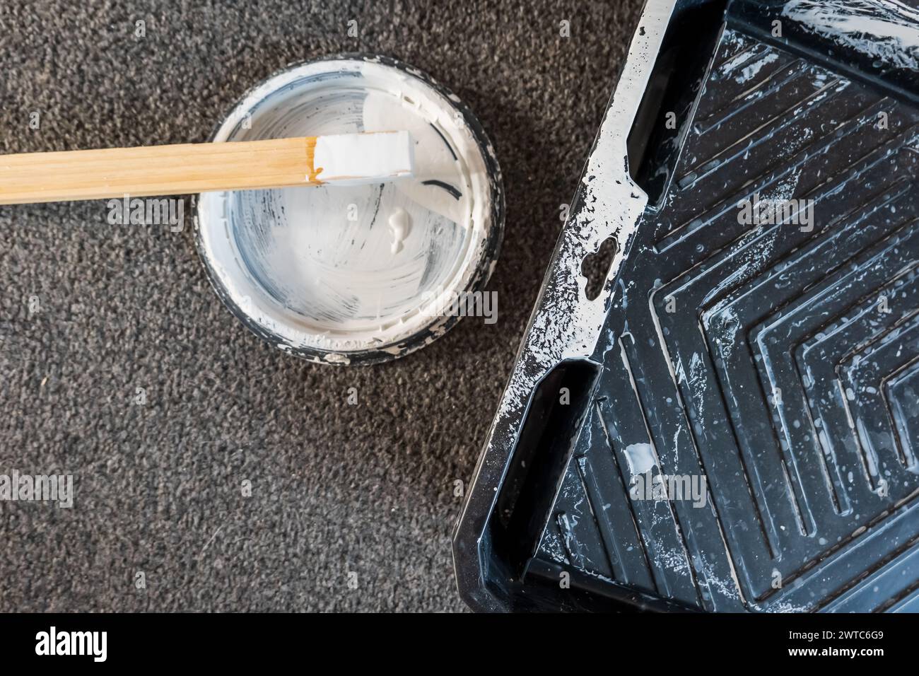 Paint tray roller with white paint are ready for painting during home ...