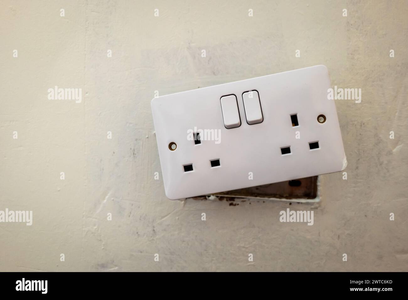 light switch out of rough painted wall texture closeup during home ...