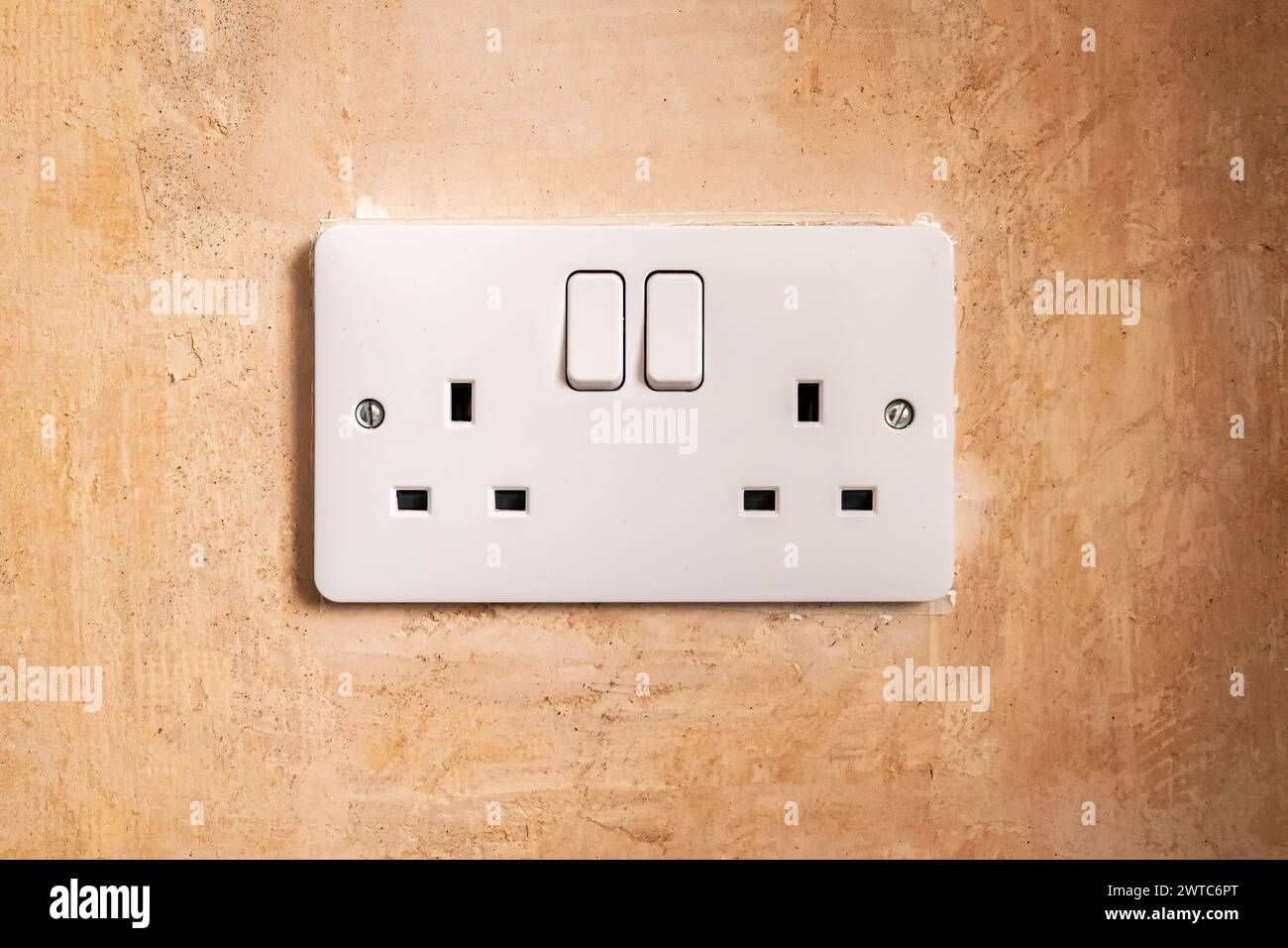 light switch on rough plastered wall texture closeup during home ...