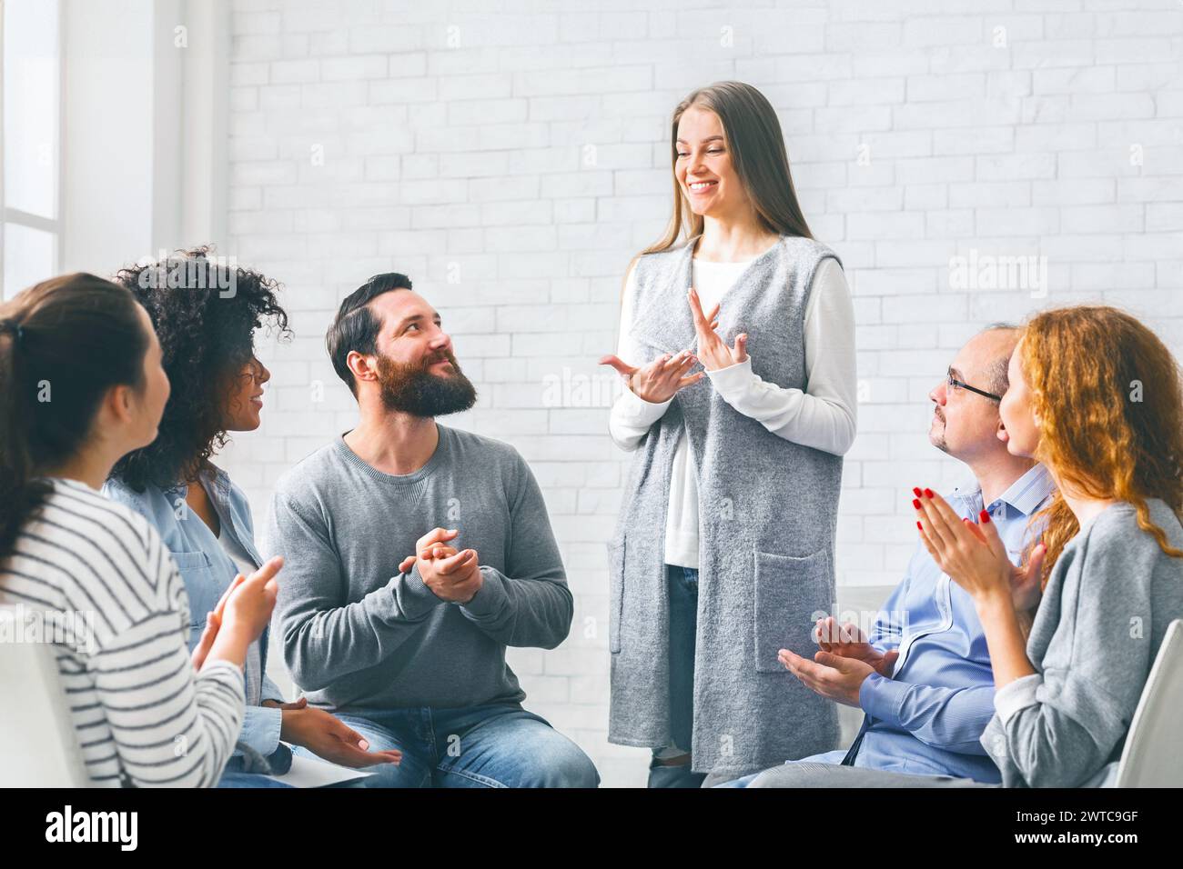 Happy Woman Sharing Her Recovery Story With Group On Therapy Session ...