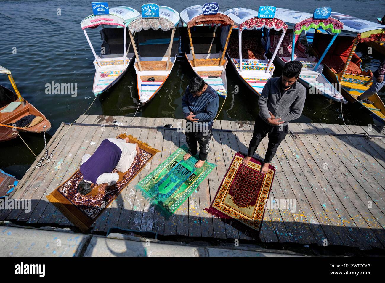 Muslim owners of shikara boats (traditional gondolas) offer prayers ...