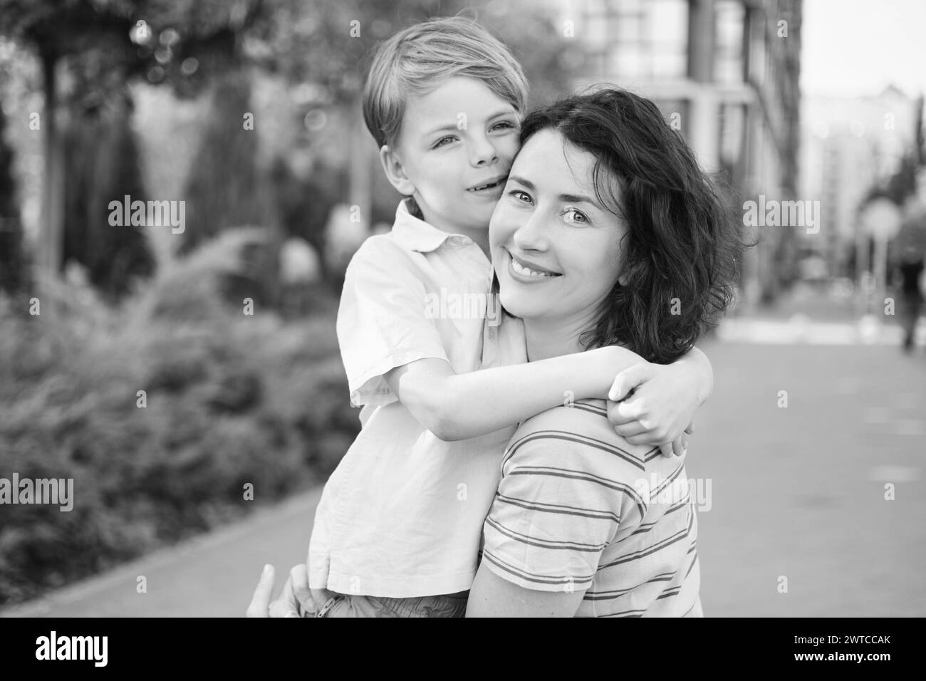 young mother and son smiling looking at the camera in modern ...
