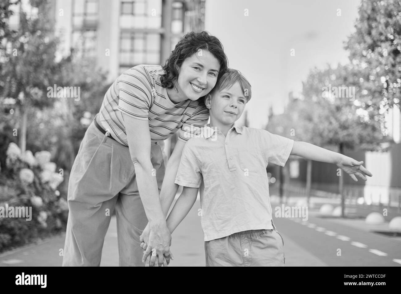 young mother and son smiling looking at the camera in modern ...