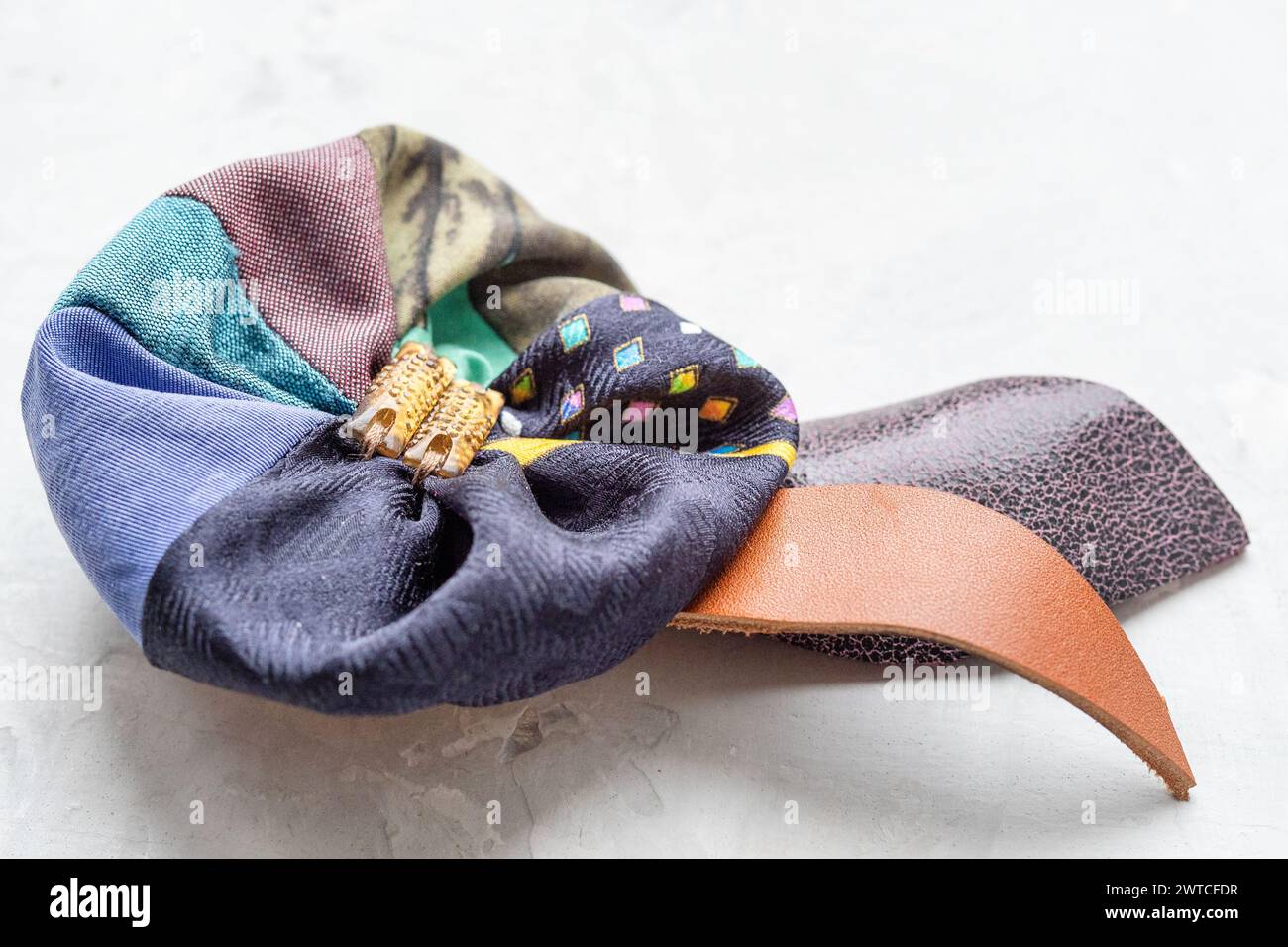 handmade brooch in shape of flower made of silk and leather closeup on ...