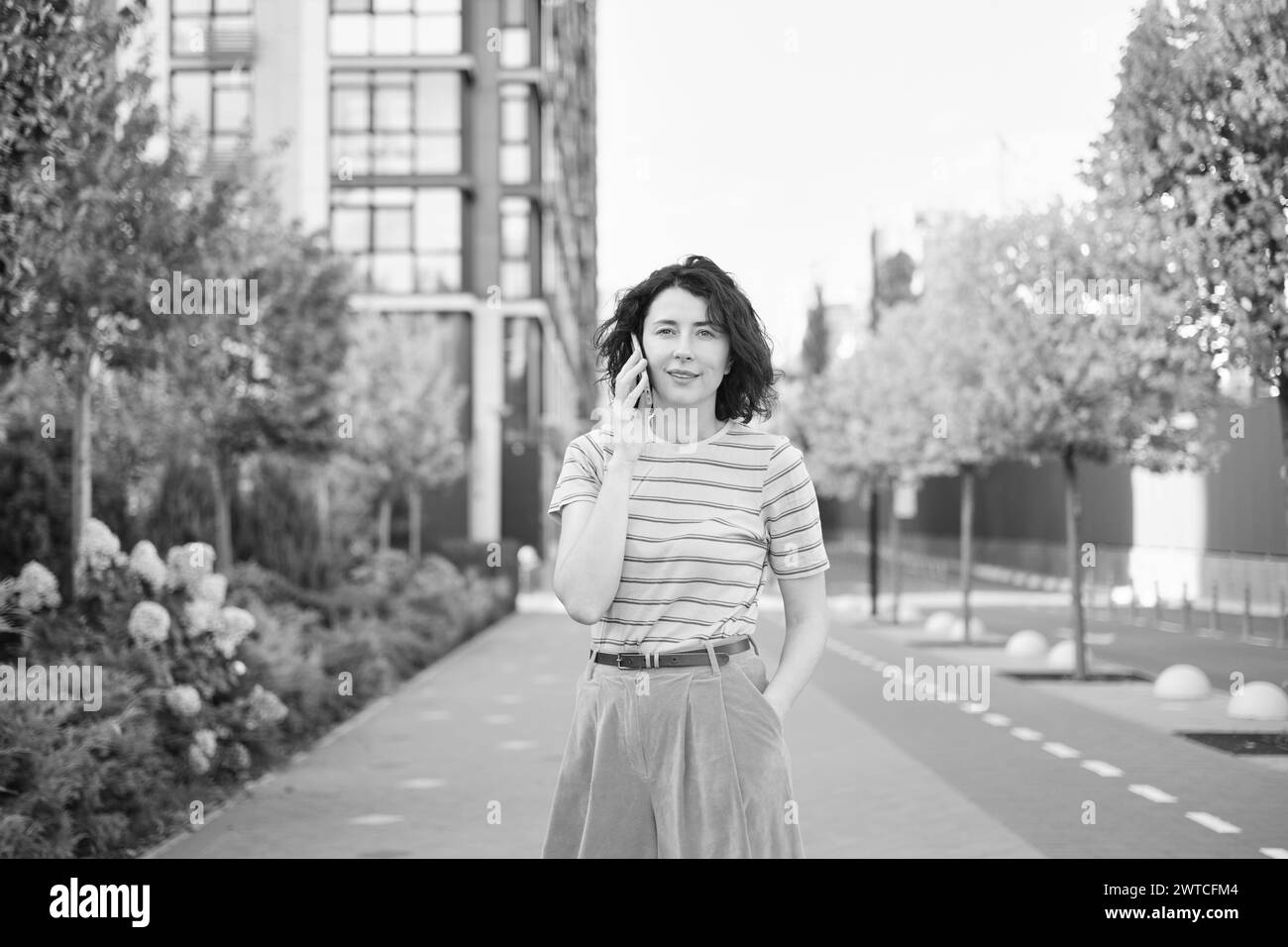 Happy young woman walking outside. One confident girl walks outdoors in ...