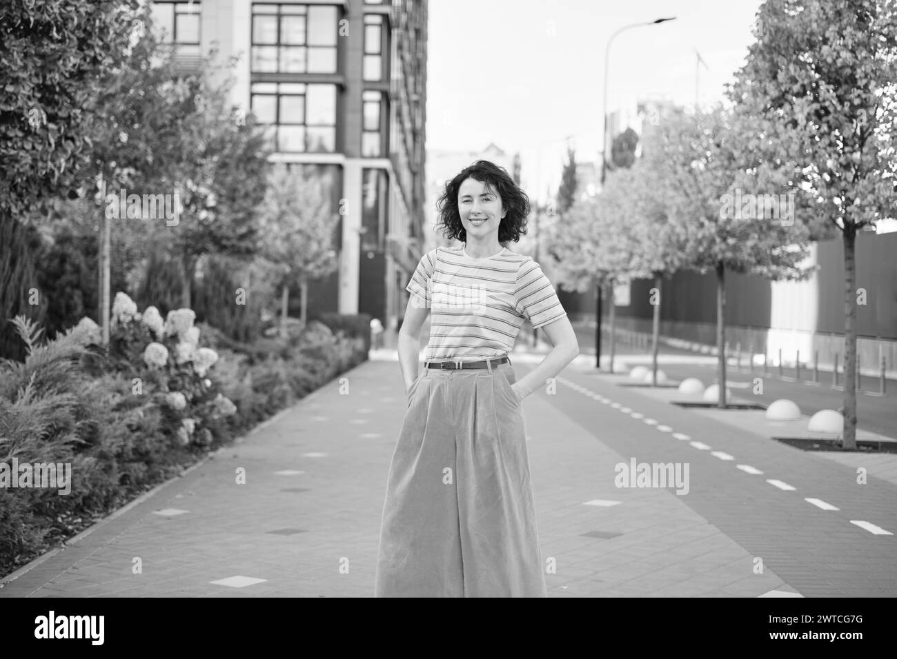 Happy young woman walking outside. One confident girl walks outdoors in ...