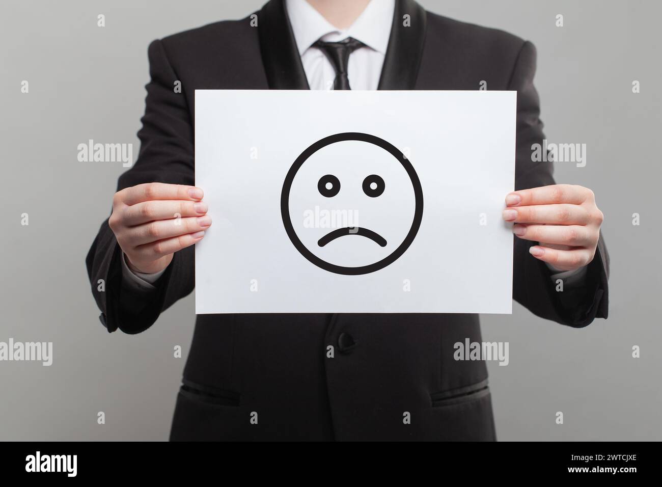 Negative person sad emoticon icon on on white paper in hand Stock Photo ...