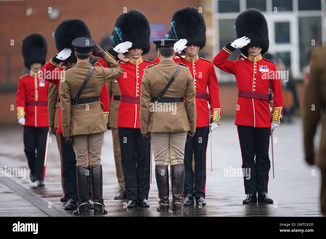 Irish Guardsmen salute officers as they stand on the Parade Square at ...