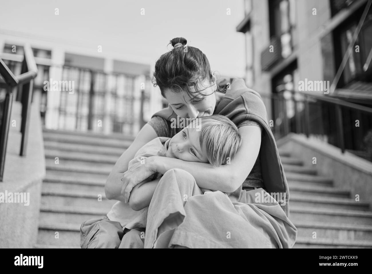 Happy family: mother and child son hugging and laugh sitting on the ...