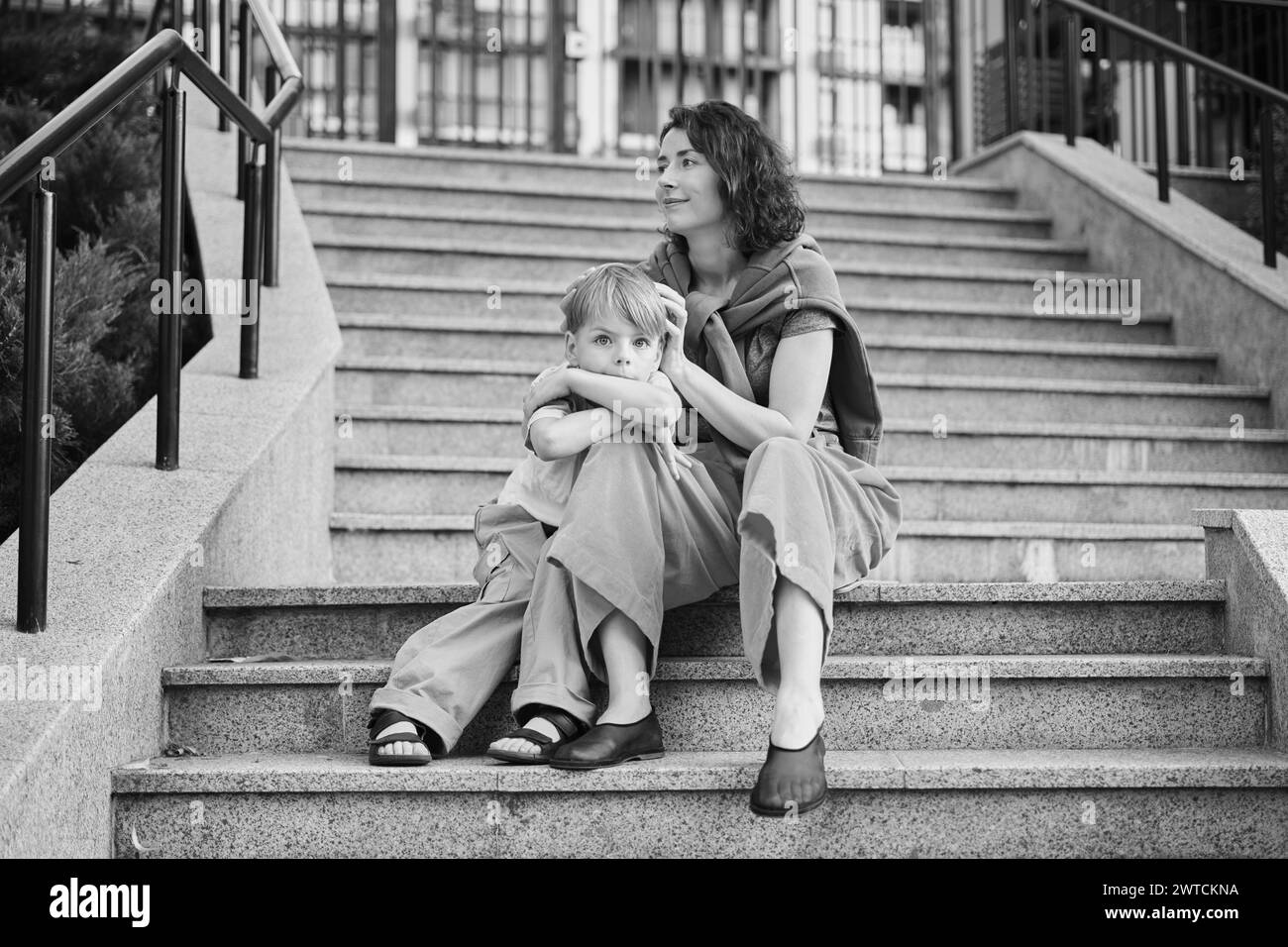 Happy family: mother and child son hugging and laugh sitting on the ...