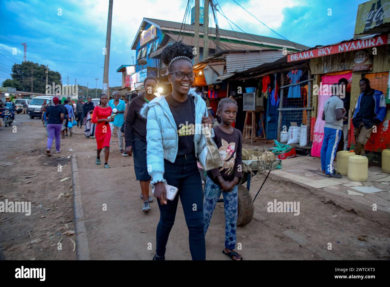 Residents walk past the busy streets in Kibera Slum headed for their ...
