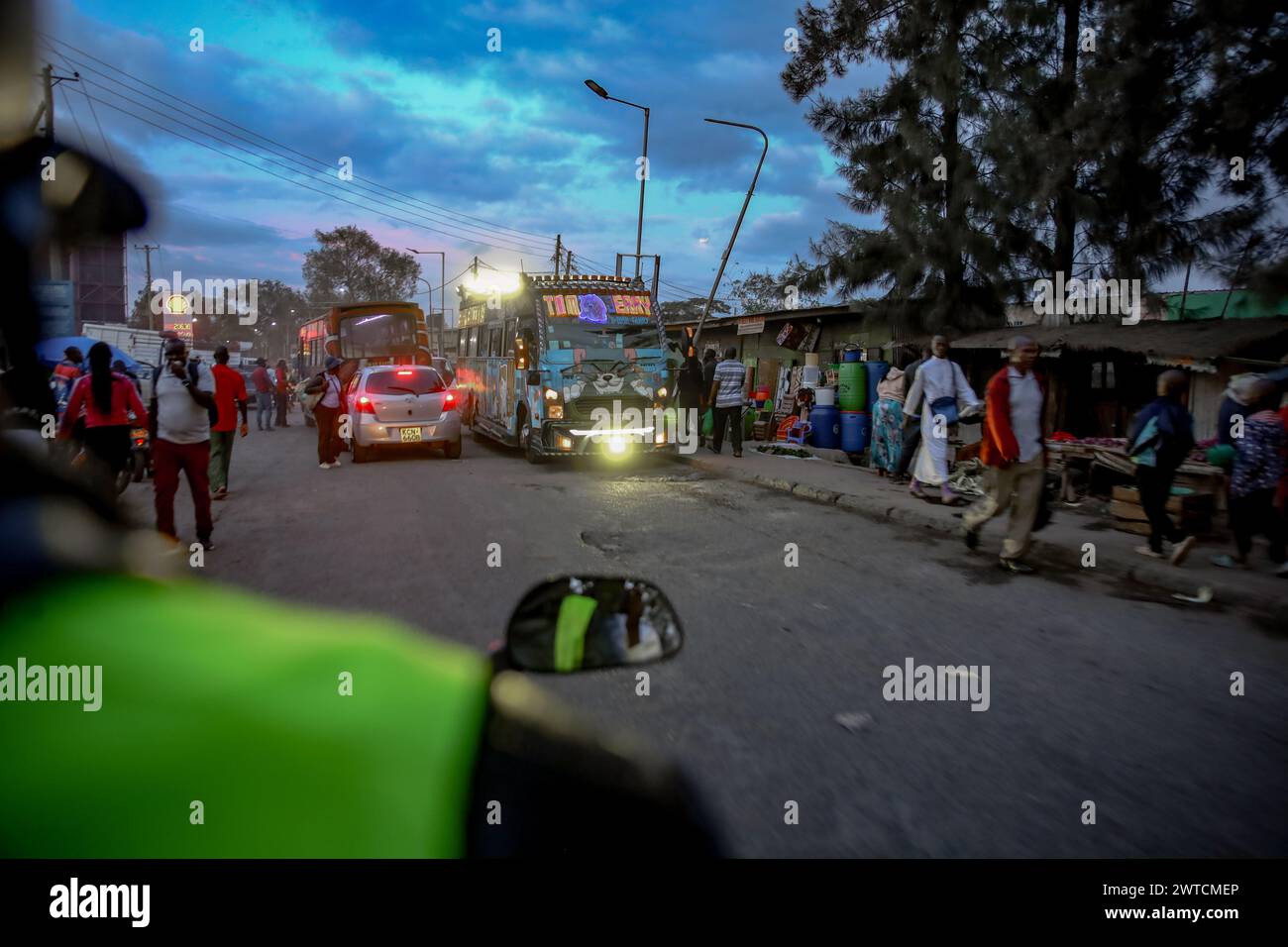 Commuters buses drive through the busy roads in Kibera Slum during ...