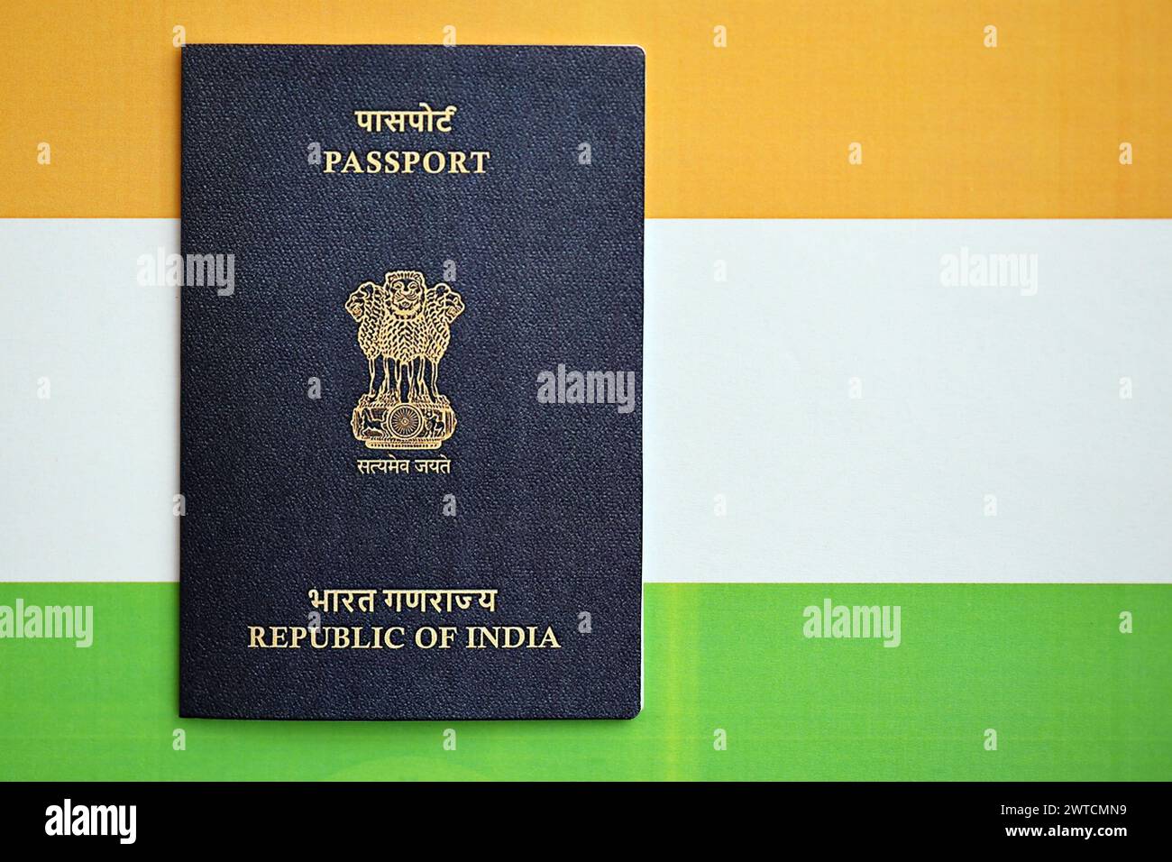 Blue Indian passport on national flag background close up. Tourism and ...