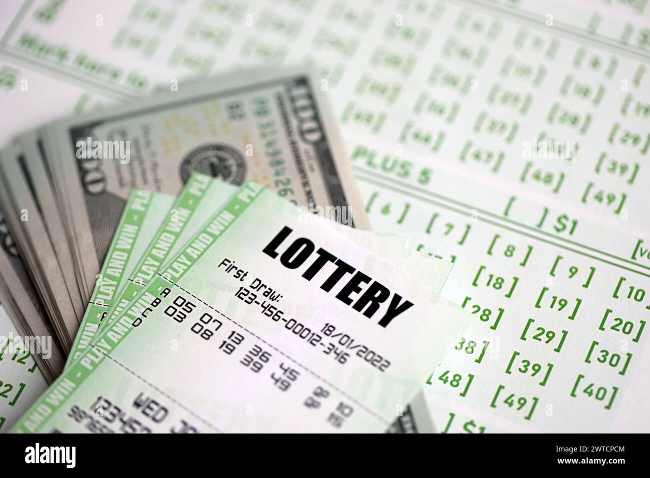 Green lottery tickets and US money bills on blank with numbers for ...