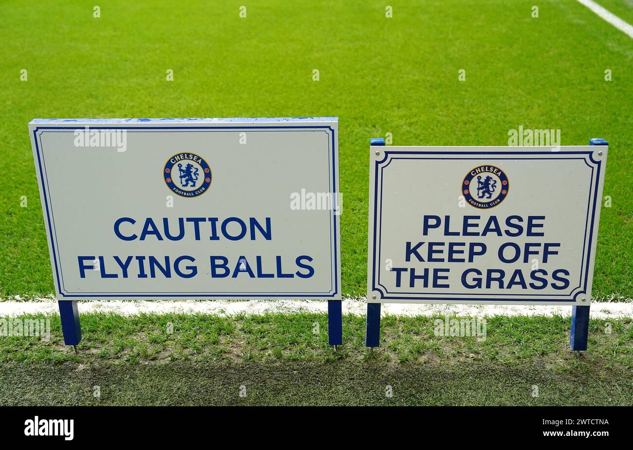Please keep off the grass and caution flying balls signs pitch side ...