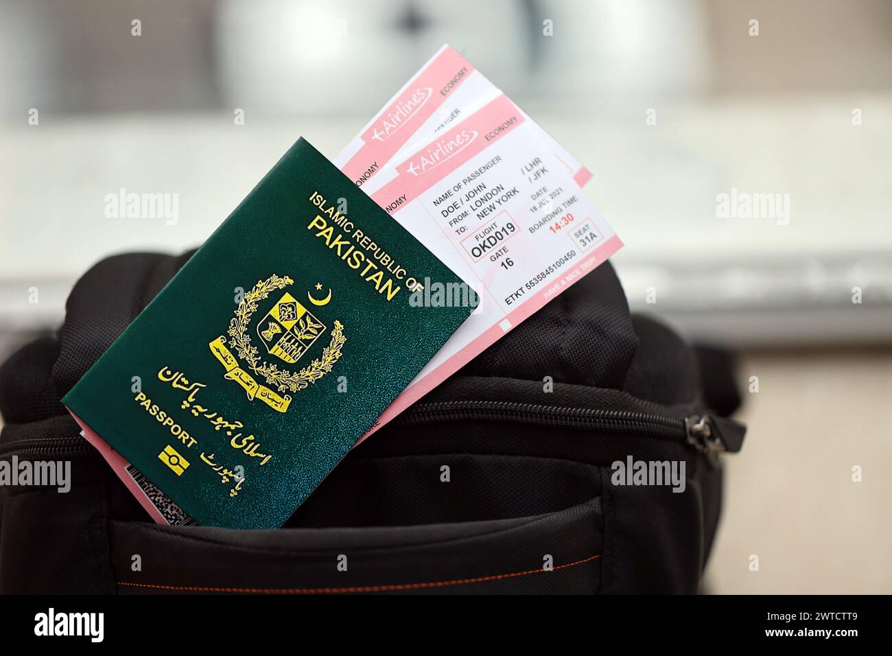 Green Islamic Republic of Pakistan passport with airline tickets on ...