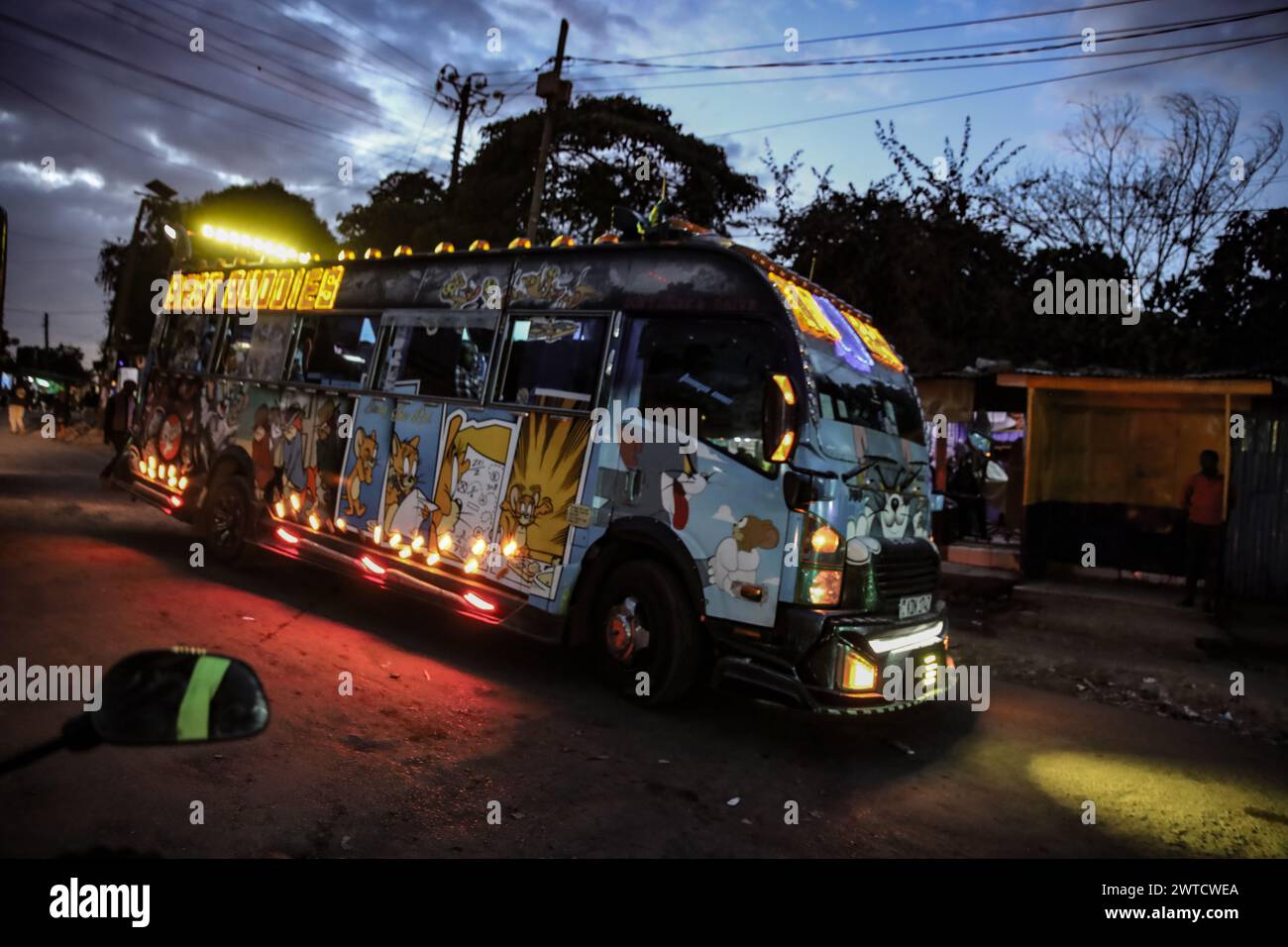 Commuters buses drive through the busy roads in Kibera Slum during ...