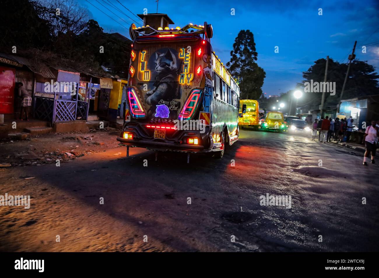 Commuters buses drive through the busy roads in Kibera Slum during ...