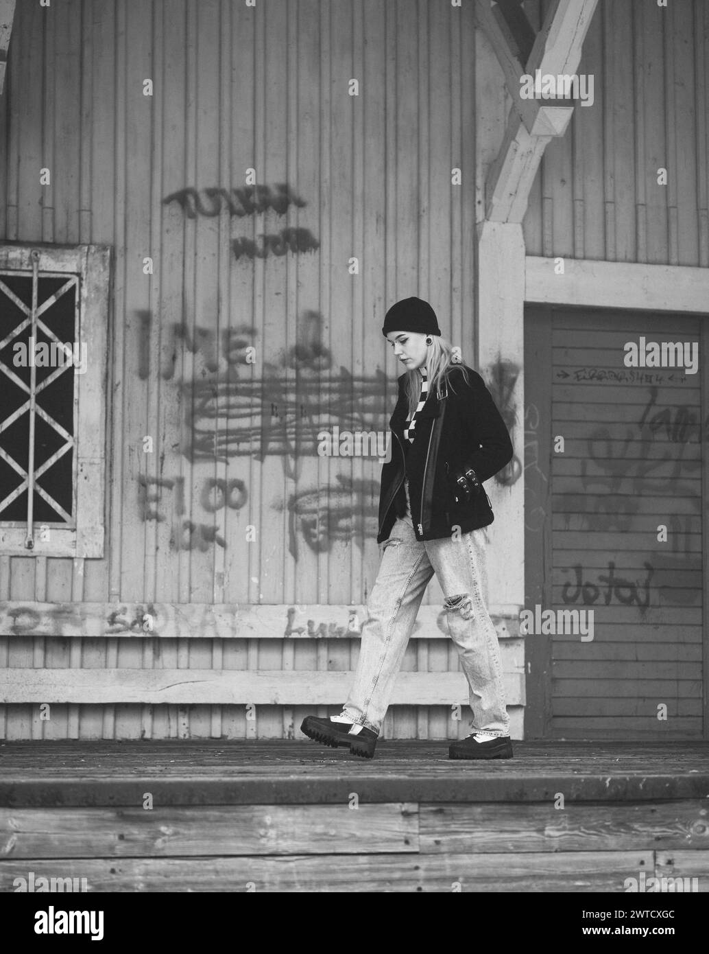 Edgy female model with piercings, beanie and blond hair. Dark tones and ...