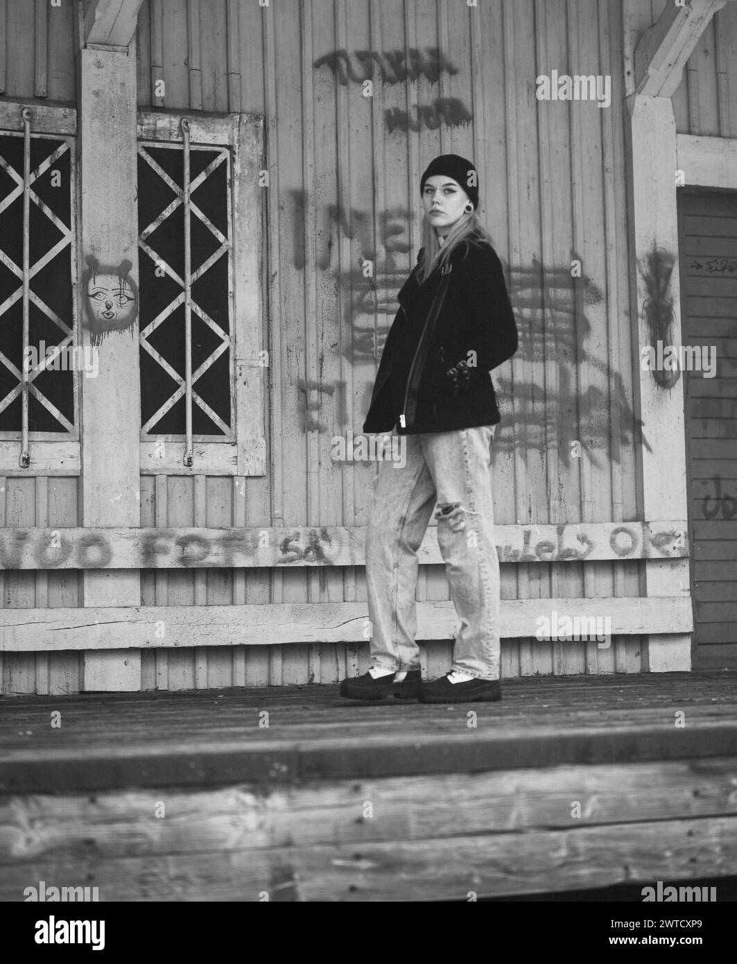 Edgy female model with piercings, beanie and blond hair. Dark tones and ...