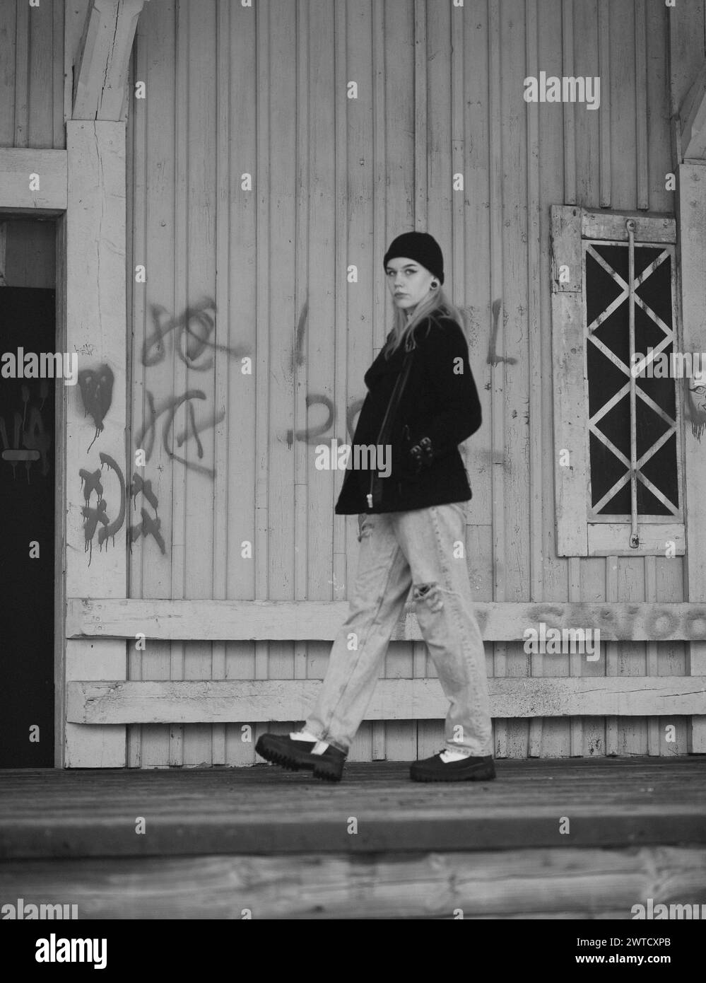 Edgy female model with piercings, beanie and blond hair. Dark tones and ...