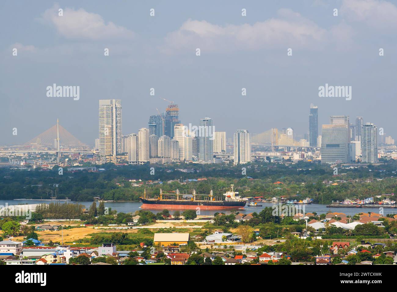 View of a cargo ship on the river and cityscape urban scape, with skyscrapers and bridges Stock ...