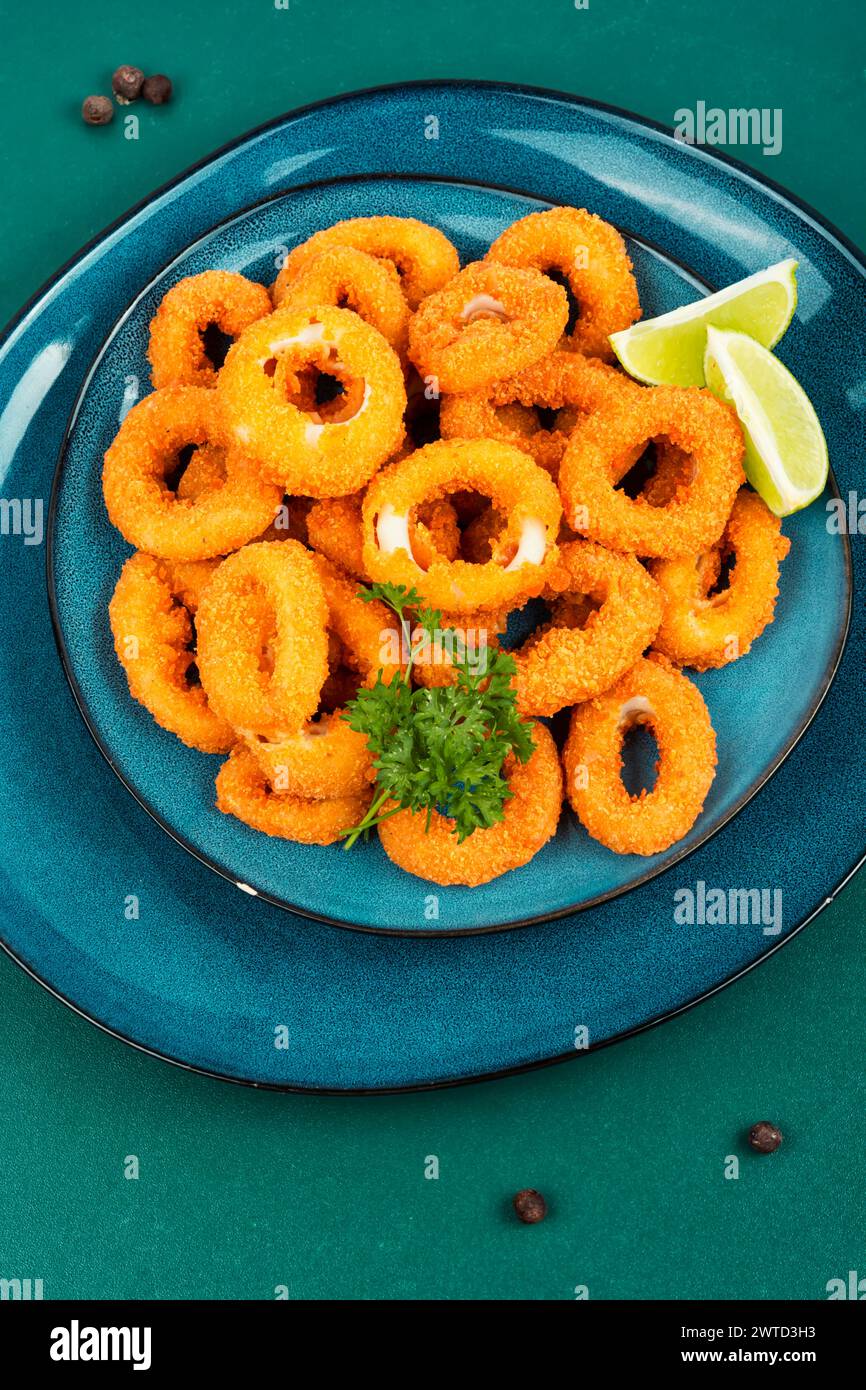 Baked breaded calamari or octopus rings. Flat lay Stock Photo - Alamy
