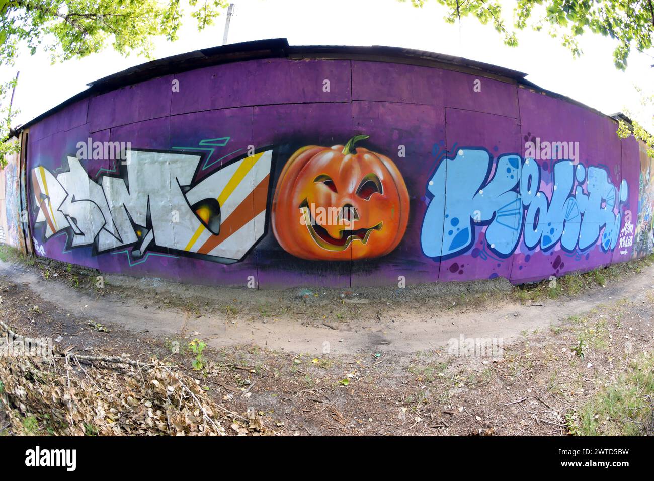 Fisheye shot of street art graffiti drawing on wall. Spray art artwork ...