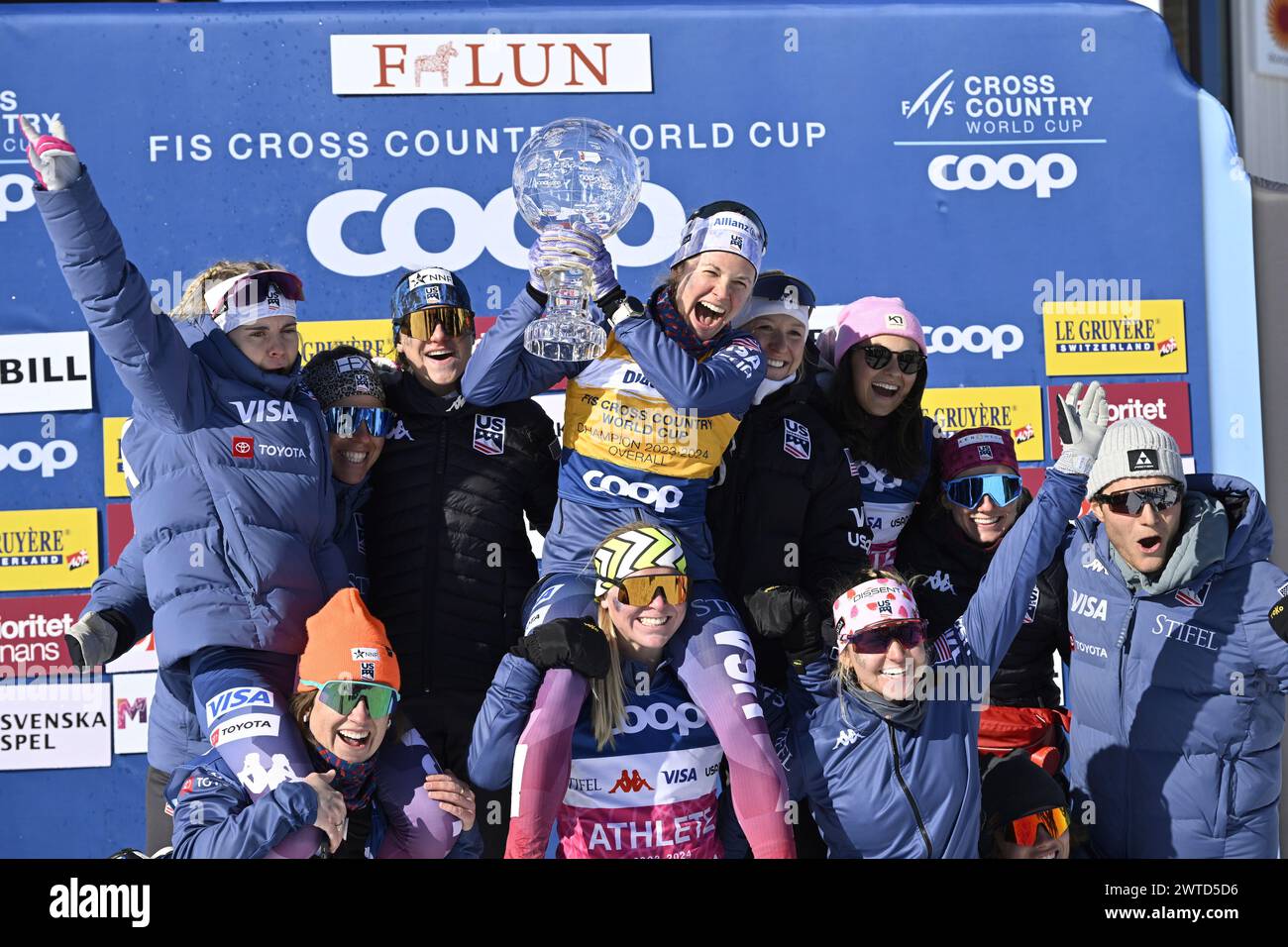Jessie Diggins of the United States holds up the trophy as she ...