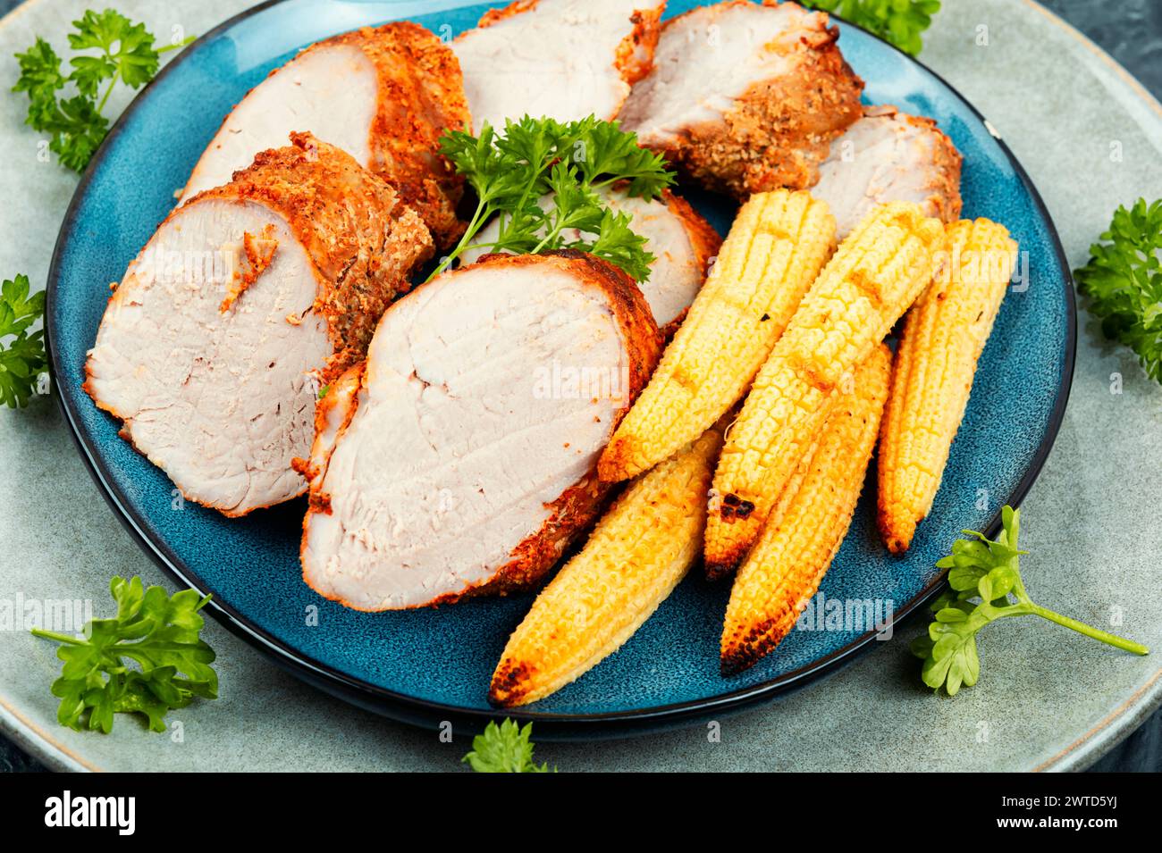 Roasted pork tenderloin with grilled corn. Baked meat Stock Photo - Alamy