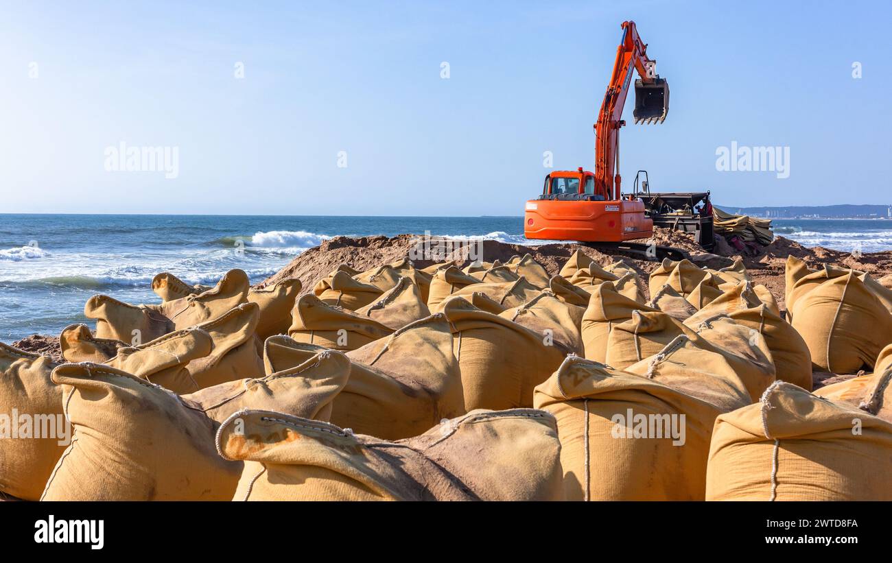 Instalment construction with excavator industrial machine on beach ...