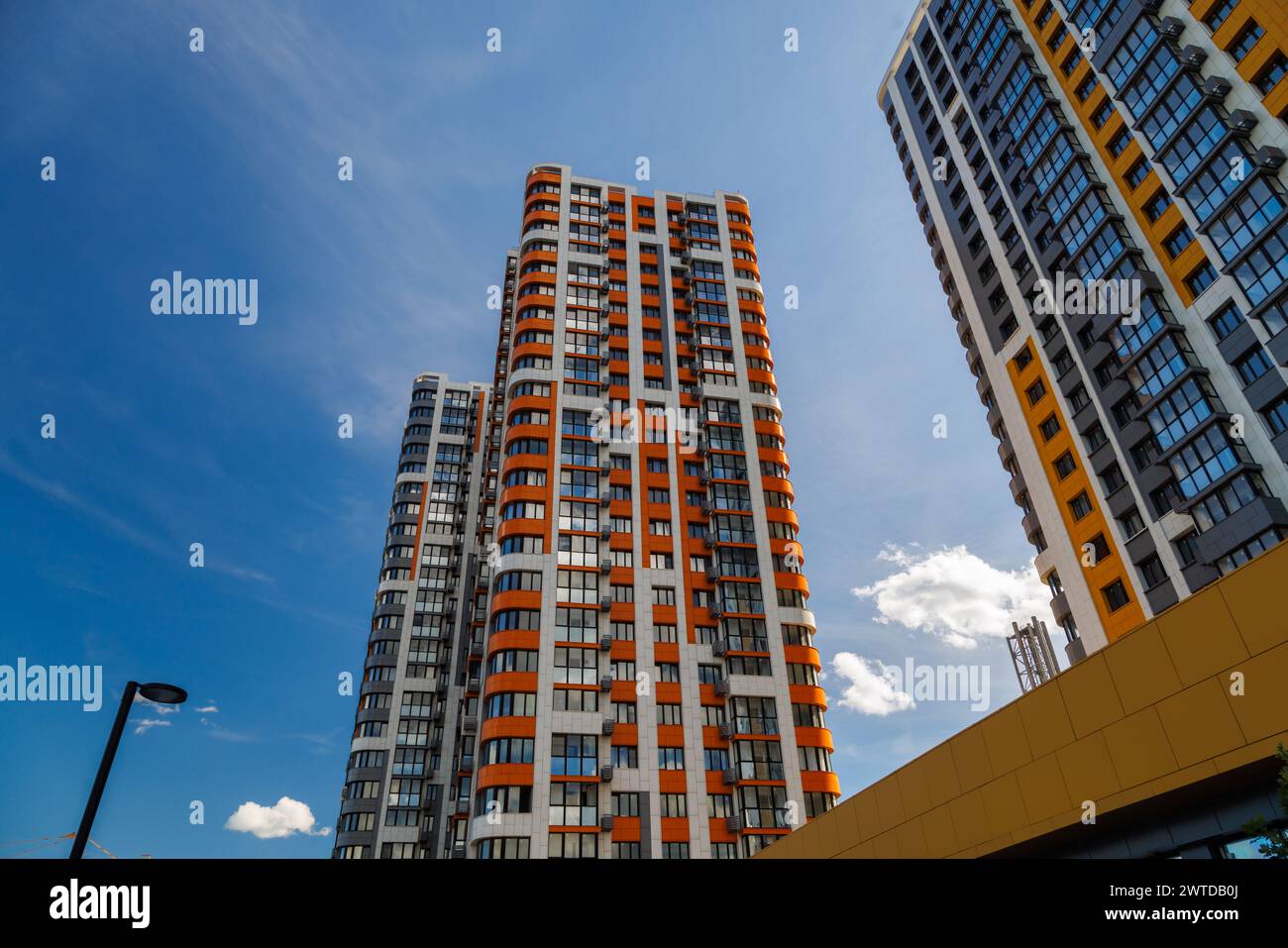freshly built high rise apartment buildings on blue sky background with ...