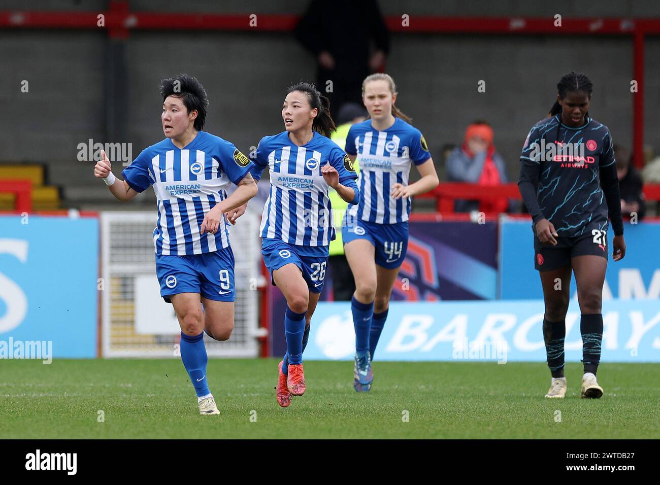 Brighton and Hove Albion's Lee Geum-min (left) celebrates scoring their ...