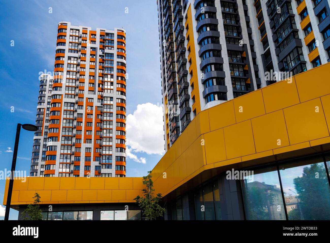 freshly built high rise apartment buildings on blue sky background with ...