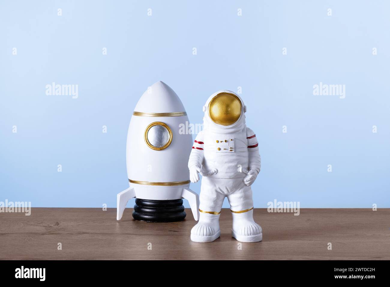 Toy rocket and figurine of astronaut. Spaceman and shuttle on wooden ...