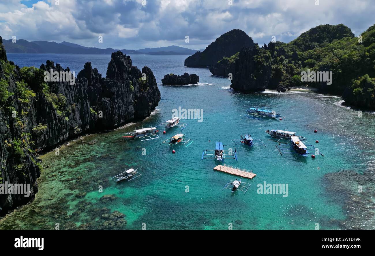 Tropical island with boats in lagoons Stock Photo - Alamy